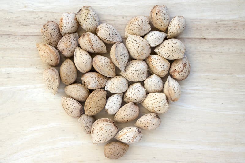Almonds in Hard Shells, Group of Nuts on Wooden Table Stock Photo ...