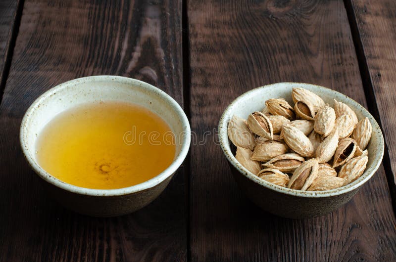 Almonds in Nutshell and Tea in Cup on Wooden Background Stock Photo ...