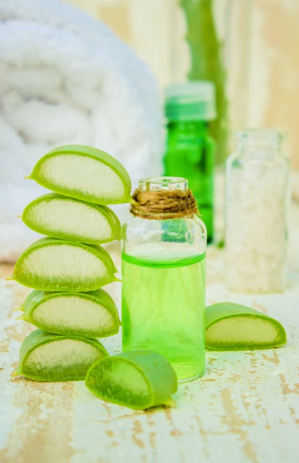 Aloe Vera Extract in a Small Bottle and Pieces on the Table. Stock ...