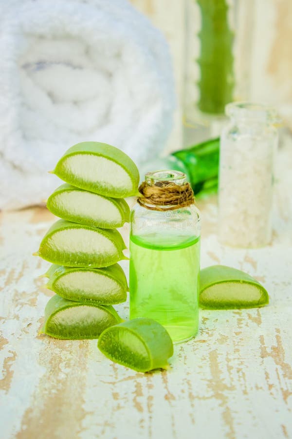 Aloe Vera Extract in a Small Bottle and Pieces on the Table. Stock ...