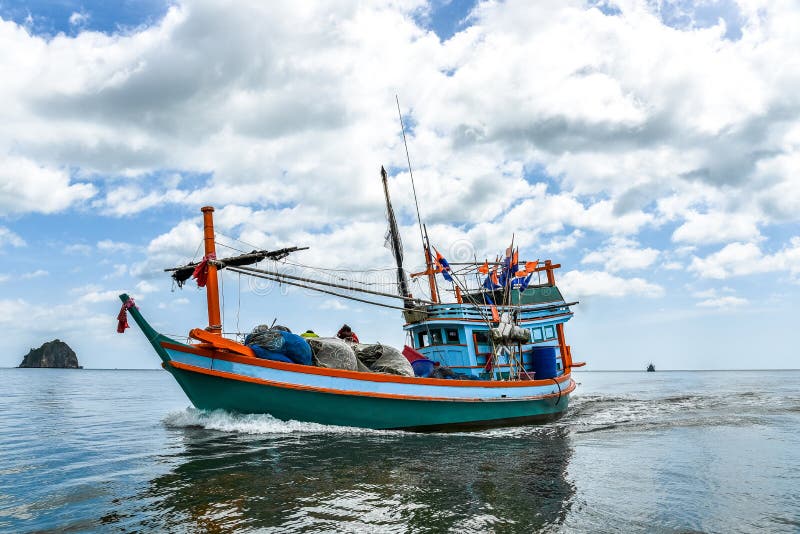 Alone Fishing Boats Float on the Sea with a Blue Sky and Clouds ...