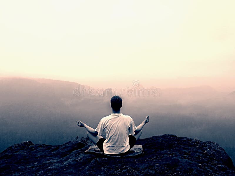 Alone Man is Doing Yoga Pose on the Rocks Peak within Misty Morning ...