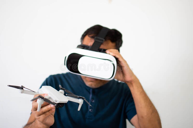 An Alone Man Holds a Drone and Plays VR To Operate the Drone. the Young ...