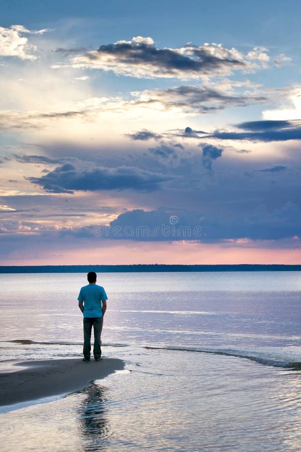 Alone man at sea in sunset stock image. Image of beach - 56203229