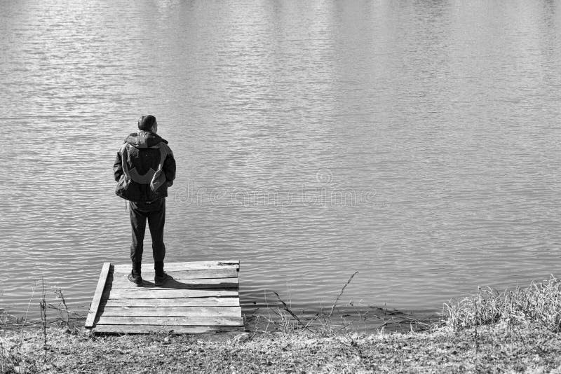 Alone Man Standing on the Edge and Staring at Lake. Back View Stock ...