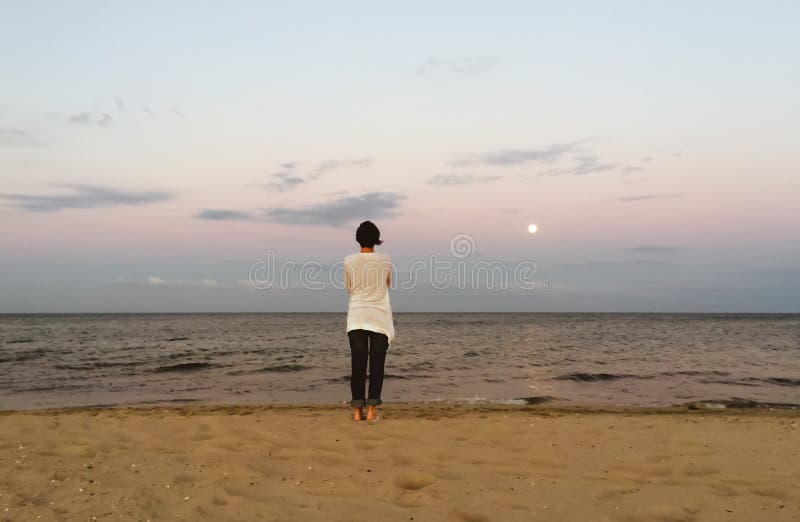 Alone person at sunset stock image. Image of seashore - 89968381