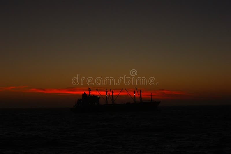 Ship in the Ocean and Red Cloud Under it Stock Image - Image of clouds ...