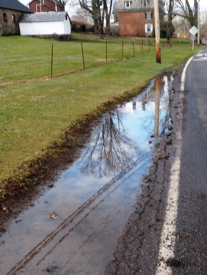 Along the Side of the Road There is a Puddle of Water. Stock Image ...