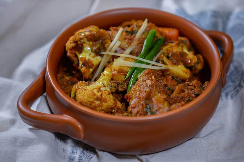 Aloo Gobi and Spring Onion Served in a Dish Isolated on Dark Background ...