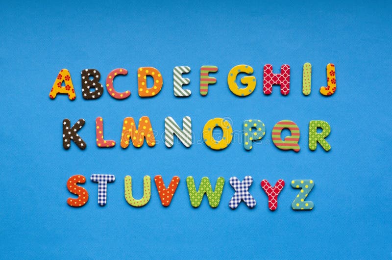 Alphabet from Bright Colored Paper Letters on Blue Paper Background ...