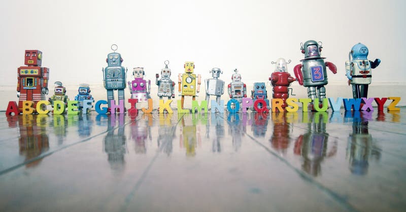 Alphabet Robots Standing on a Wooden Floor Stock Photo - Image of ...