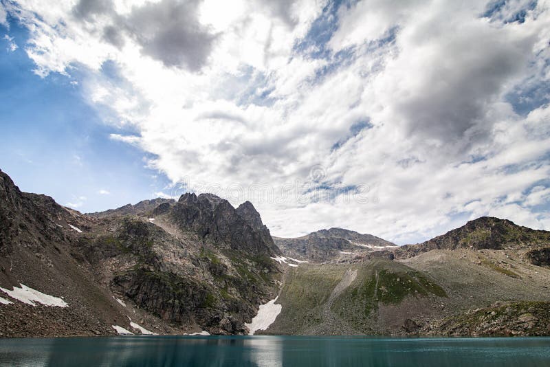 Alpine Lake among the Rocks Stock Image - Image of caucasus, plain ...