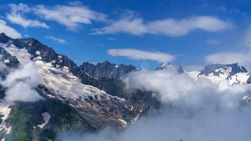 Alpine Landscape. High Mountains in the Clouds Stock Photo - Image of ...