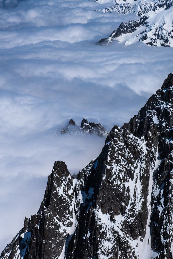 Alpine Mountain Ridges Emerging through Cloud Cover on Top Stock Photo ...