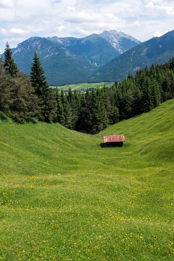 Alpine Pasture with Mountains, a Hut and a Meadow Stock Photo - Image ...