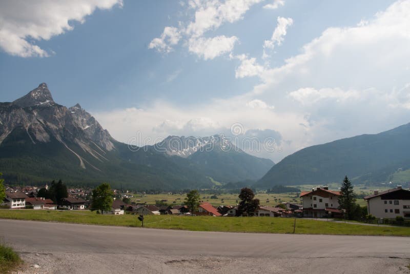 Alpine Scene with a Road in the Foreground Stock Image - Image of ...