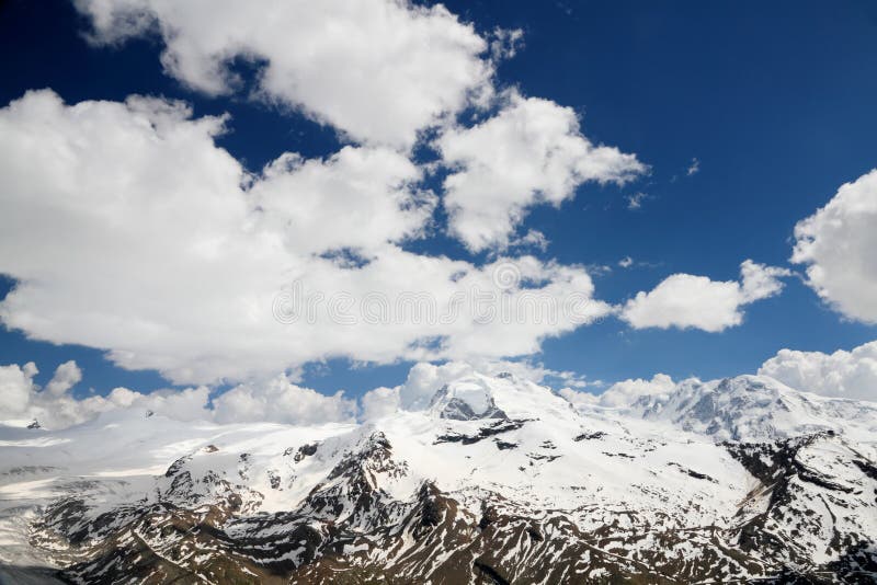 Alpine snowy mountains stock photo. Image of clouds, rocky - 16740326