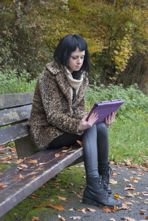 Alternative Model Sat on Bench with Tablet PC Stock Image - Image of ...