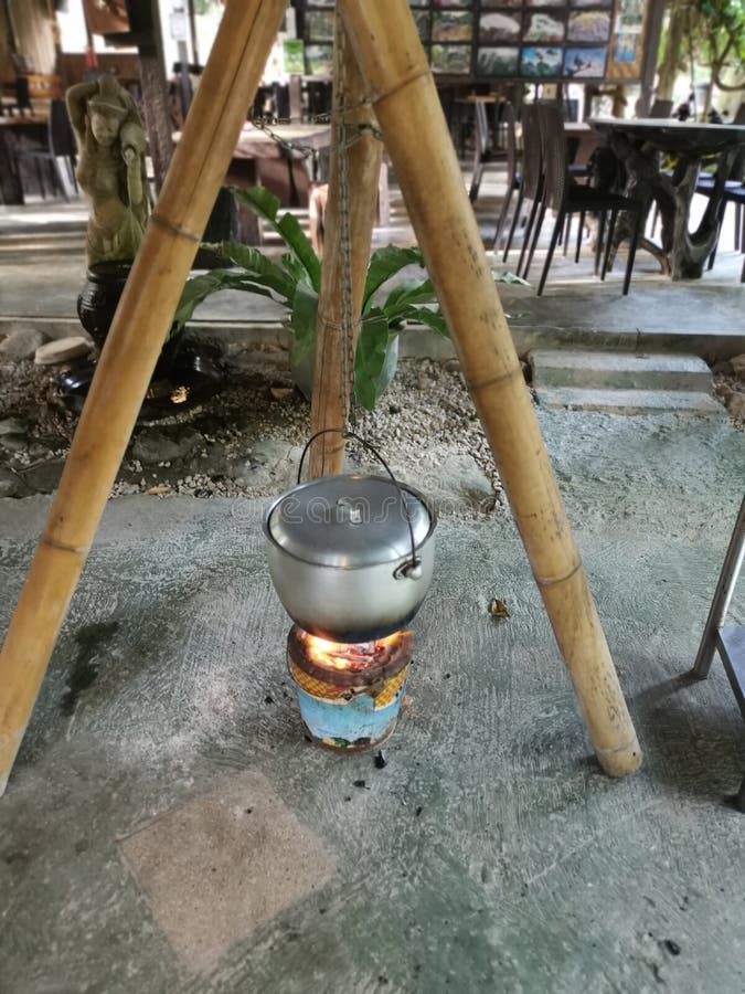 Aluminum Cooking Pot with Handle Hanging on the Bamboo Pole Cooking on ...