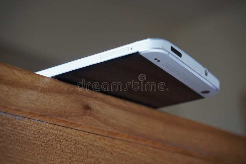 Aluminum Phone Balancing on the Edge of the Wooden Table As a Concept ...