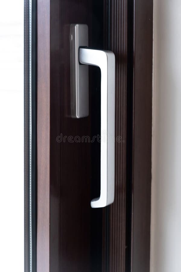 Aluminum Silver Handle on Close Door, Window Against Brown Frame ...