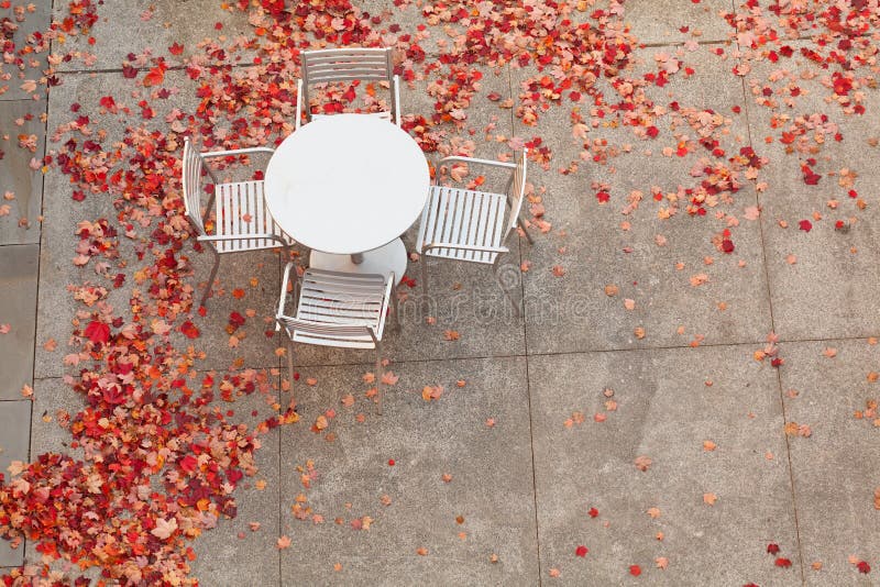 Table Set Surrounded by Fallen Leaves Stock Photo - Image of chairs ...