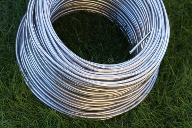 Aluminum Wire Coil on the Grass Stock Photo - Image of alms, canter ...