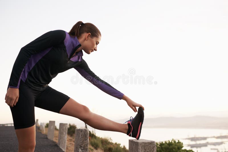 Alway Stretch before Exercise. a Young Woman Stretching before a Run ...