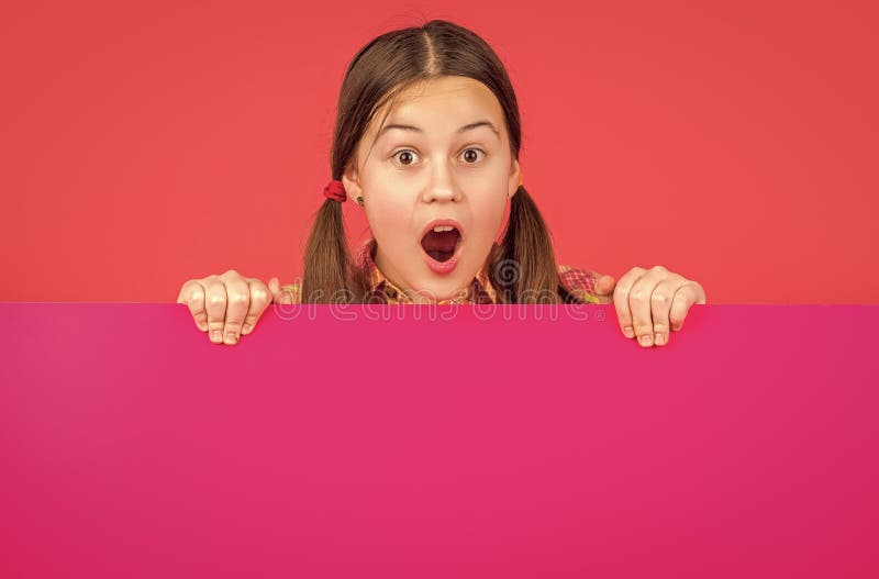 Amazed Kid Behind Blank Pink Paper with Copy Space for Advertisement ...