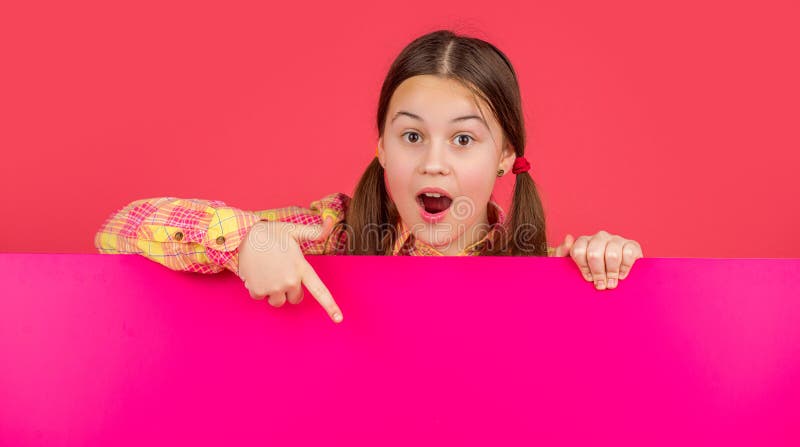Amazed Kid Behind Blank Pink Paper with Copy Space for Advertisement ...