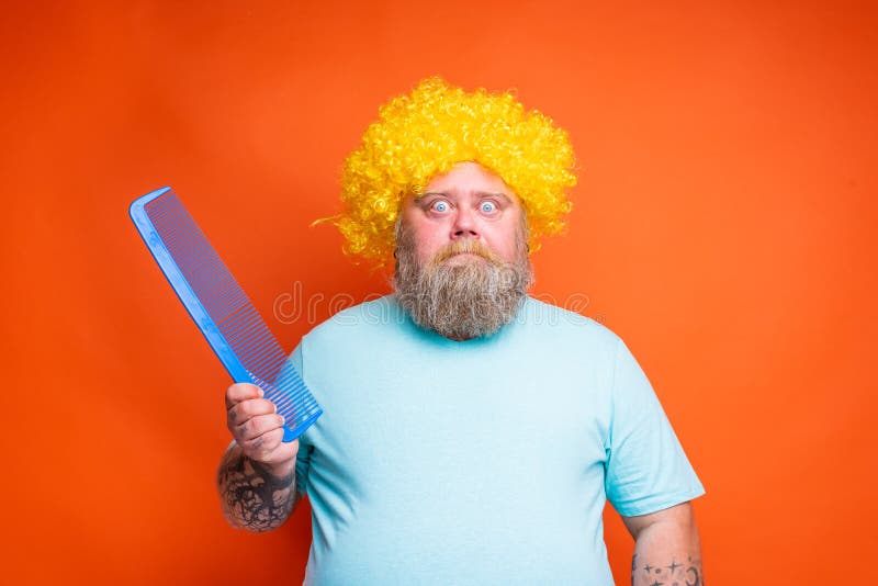 Fat Amazed Man with Beard, Tattoos and Sunglasses Combs Himself with a ...