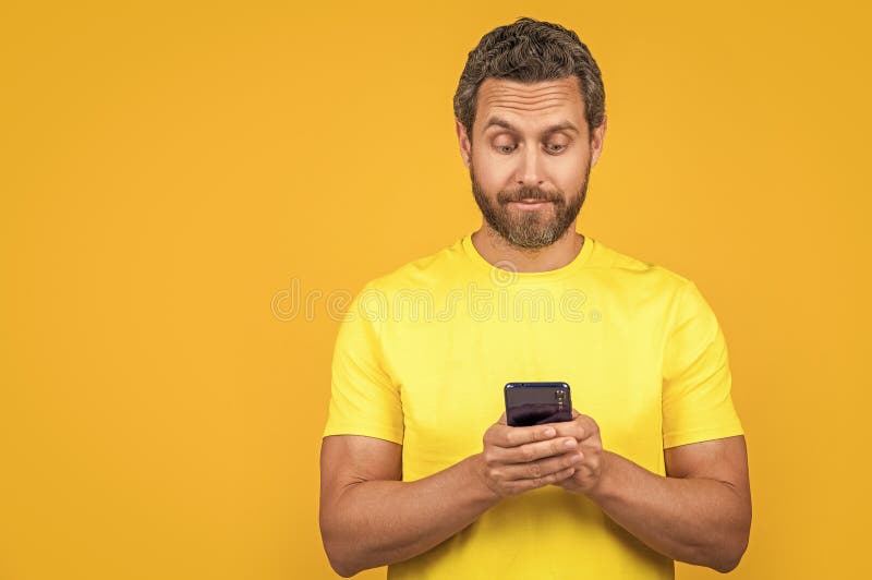 Amazed Man Texting on Phone in Studio. Photo of Man Texting on Phone ...
