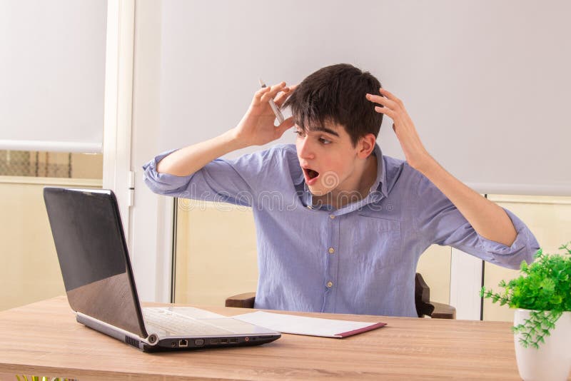 Scared Teenage Student at Desk with Computer Stock Photo - Image of ...