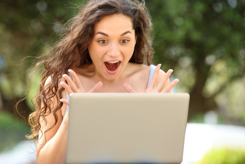 Amazed Woman Checking Laptop in a Park Stock Photo - Image of ecommerce ...