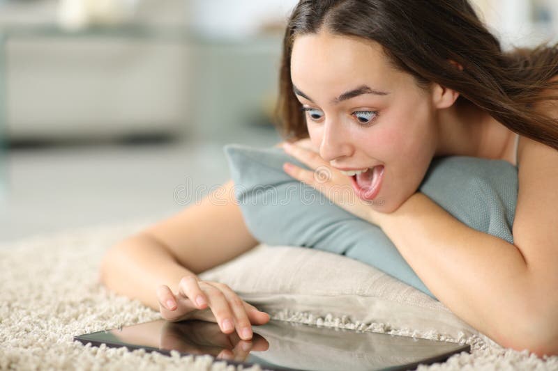 Amazed Woman Checking Tablet on the Floor Stock Photo - Image of ...