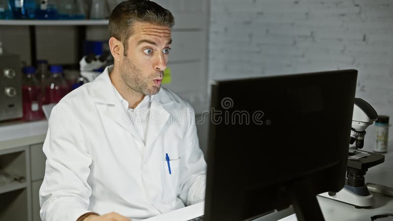 Amazed Young Hispanic Man Scientist, Mouth Wide Open in Disbelief ...