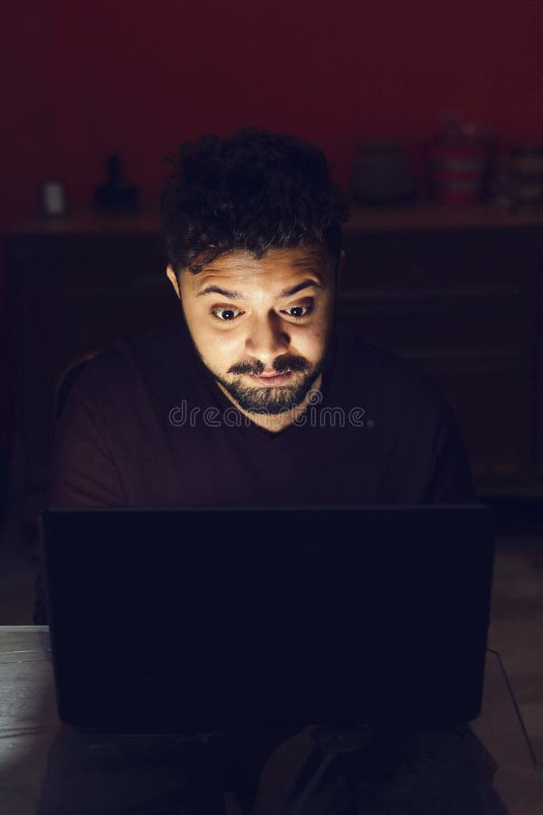 Amazed Young Man Looking at Laptop Computer in Dark Stock Photo - Image ...