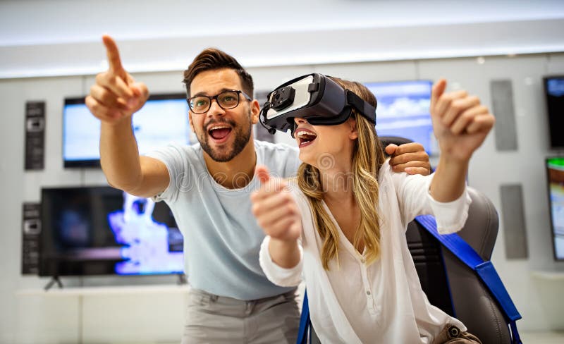 Amazed Young People Touching the Air during the Virtual Reality Experience. Technology Fun ...