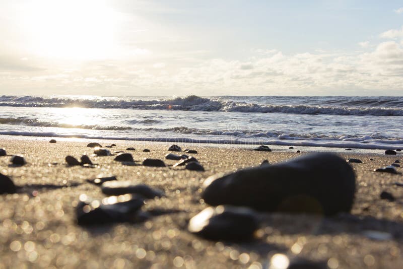 Amazing Beach Sunset with Endless Horizon and Stones in the Foreground ...