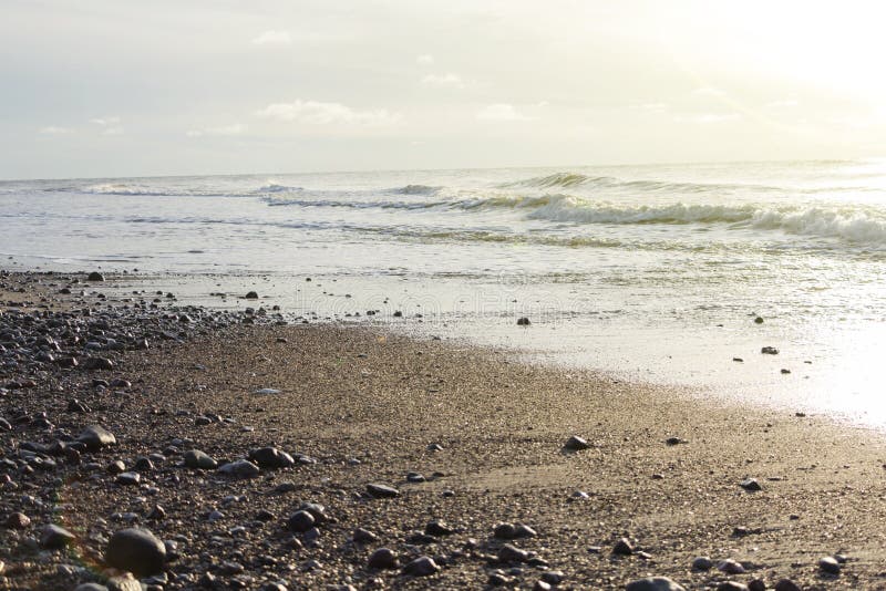 Amazing Beach Sunset with Endless Horizon and Stones in the Foreground ...