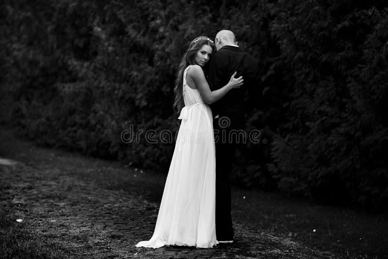 Amazing Bride Hugs a Groom Looking Over His Shoulder Stock Image ...