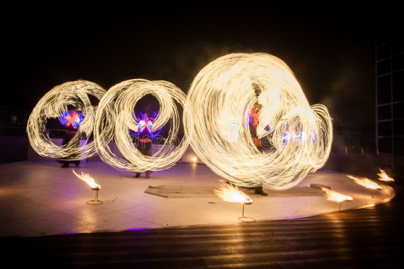 Amazing Fire Show Dance. Fire Dancers in Beautiful Costumes Playing ...