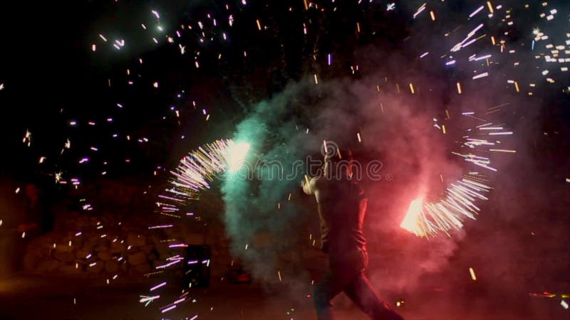 An Amazing Fire Show at Night. a Woman Spinning Fire. Back View of ...