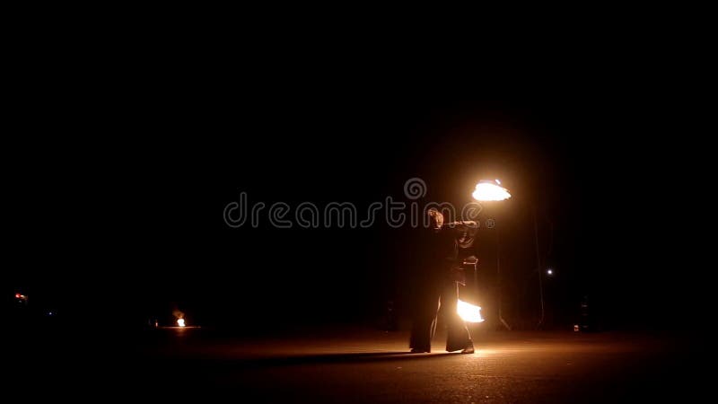 An Amazing Fire Show at Night. a Woman Spinning Fire. Back View of ...