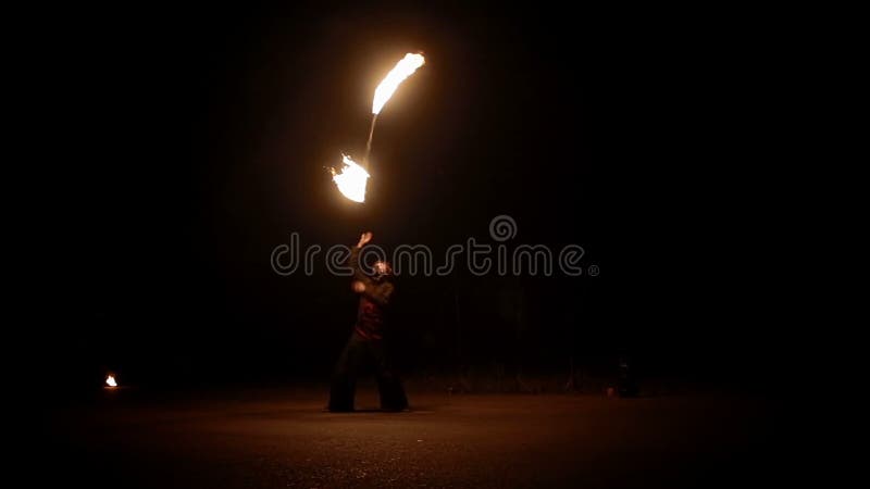An Amazing Fire Show at Night. a Woman Spinning Fire. Back View of ...