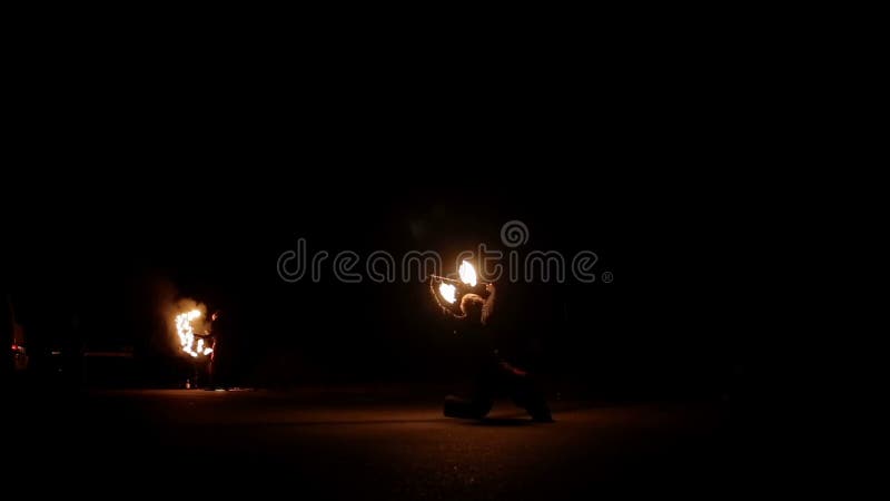 An Amazing Fire Show at Night. a Woman Spinning Fire. Back View of ...
