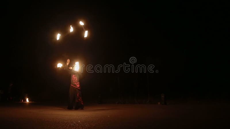 An Amazing Fire Show at Night. a Woman Spinning Fire. Back View of ...