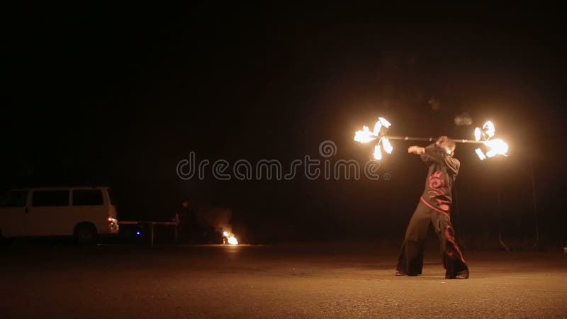 An Amazing Fire Show at Night. a Woman Spinning Fire. Back View of ...