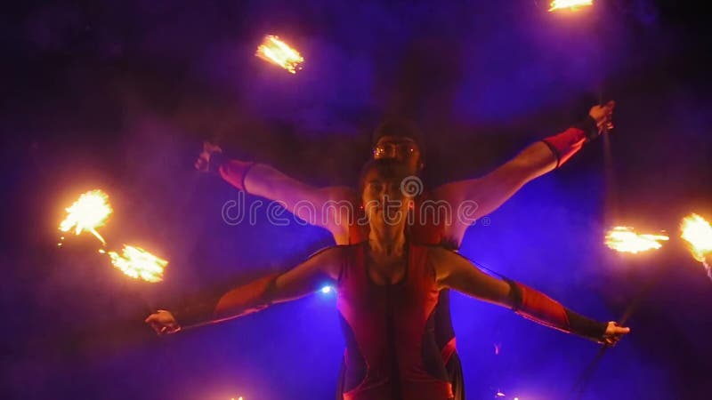 An Amazing Fire Show at Night. a Woman Spinning Fire. Back View of ...