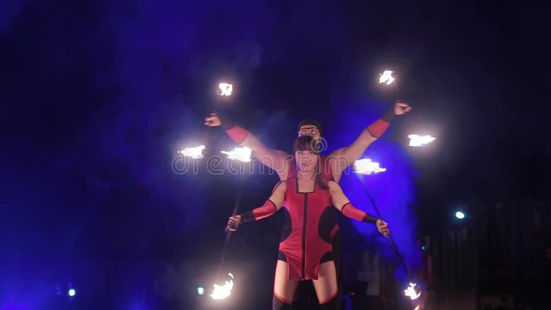 An Amazing Fire Show at Night. a Woman Spinning Fire. Back View of ...